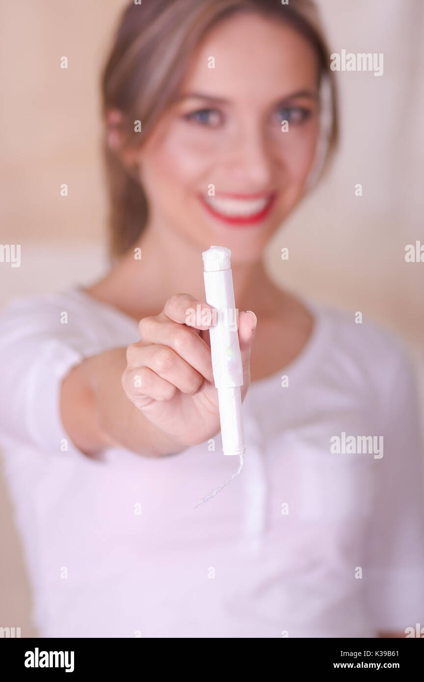 Young beautiful smiling woman pointing in front of her a menstruation ...