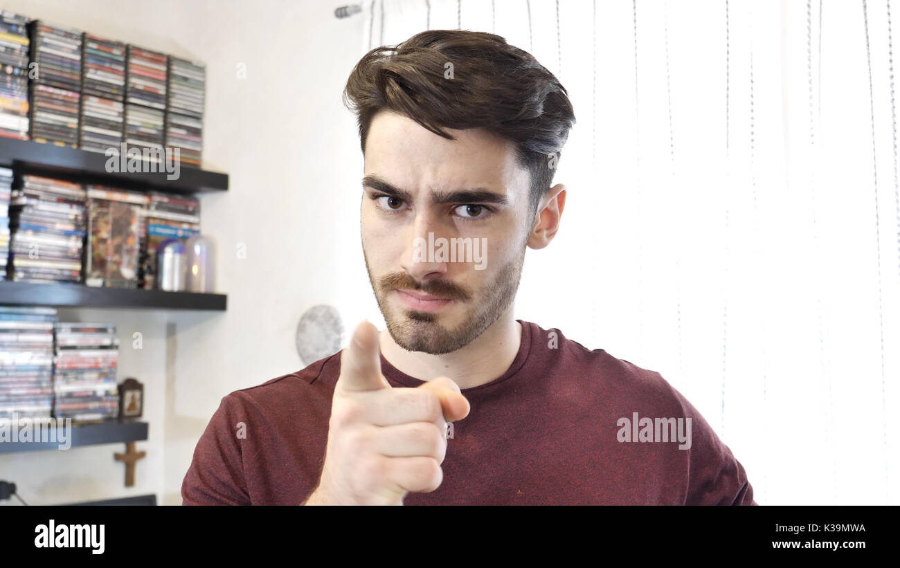 Confused or doubtful young man looking up Stock Photo - Alamy