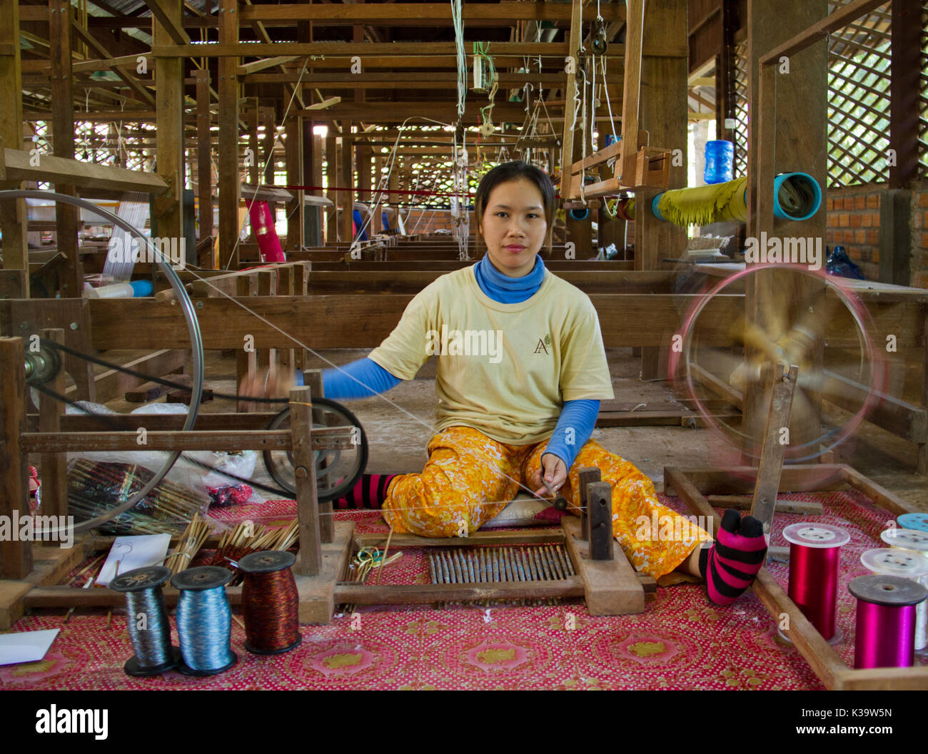 Woman creating thread at a silk factory in Siem Reap, Cambodia on Oct ...