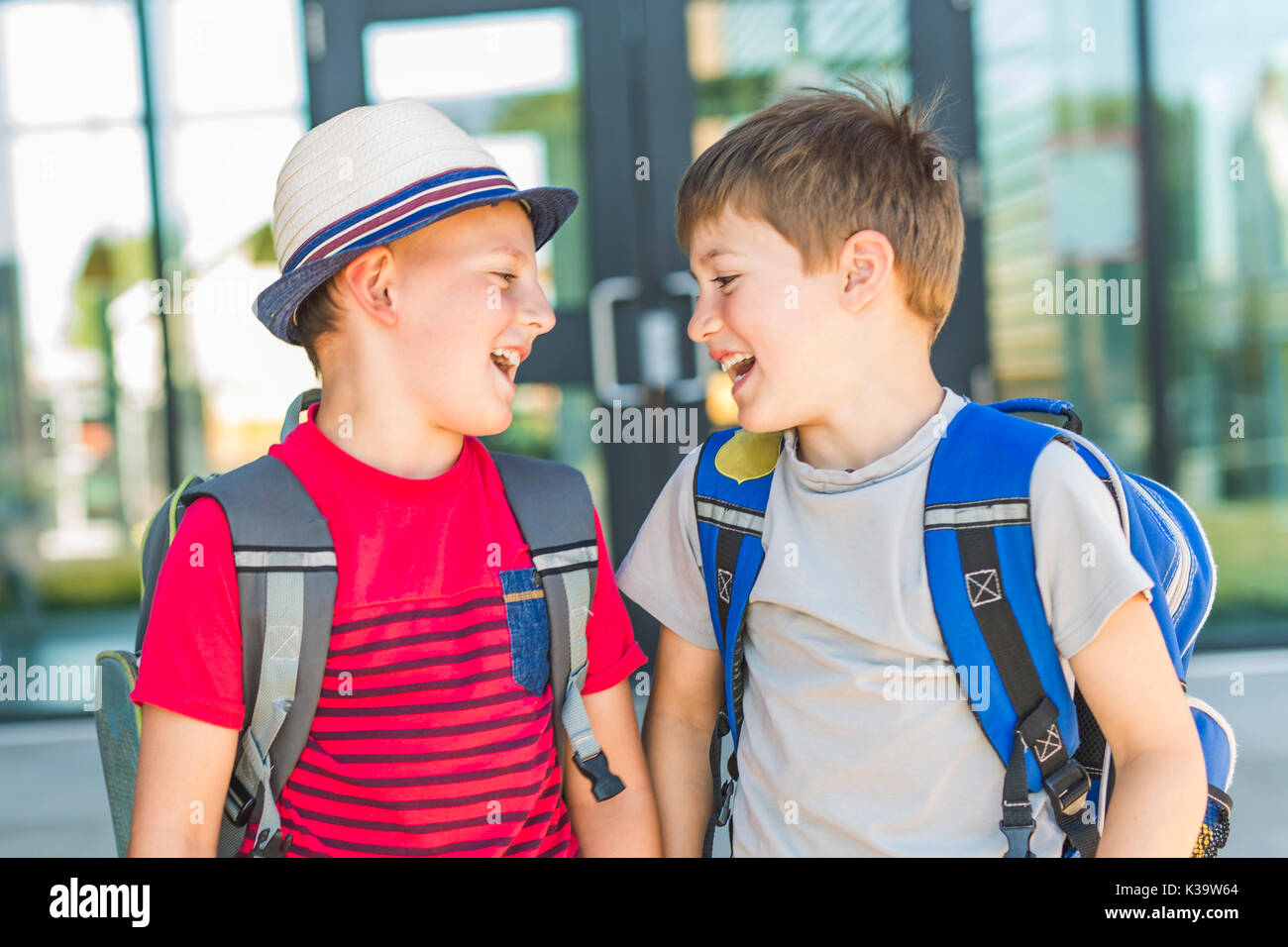 Boy Standing Outside School With Rucksack Stock Photo - Alamy