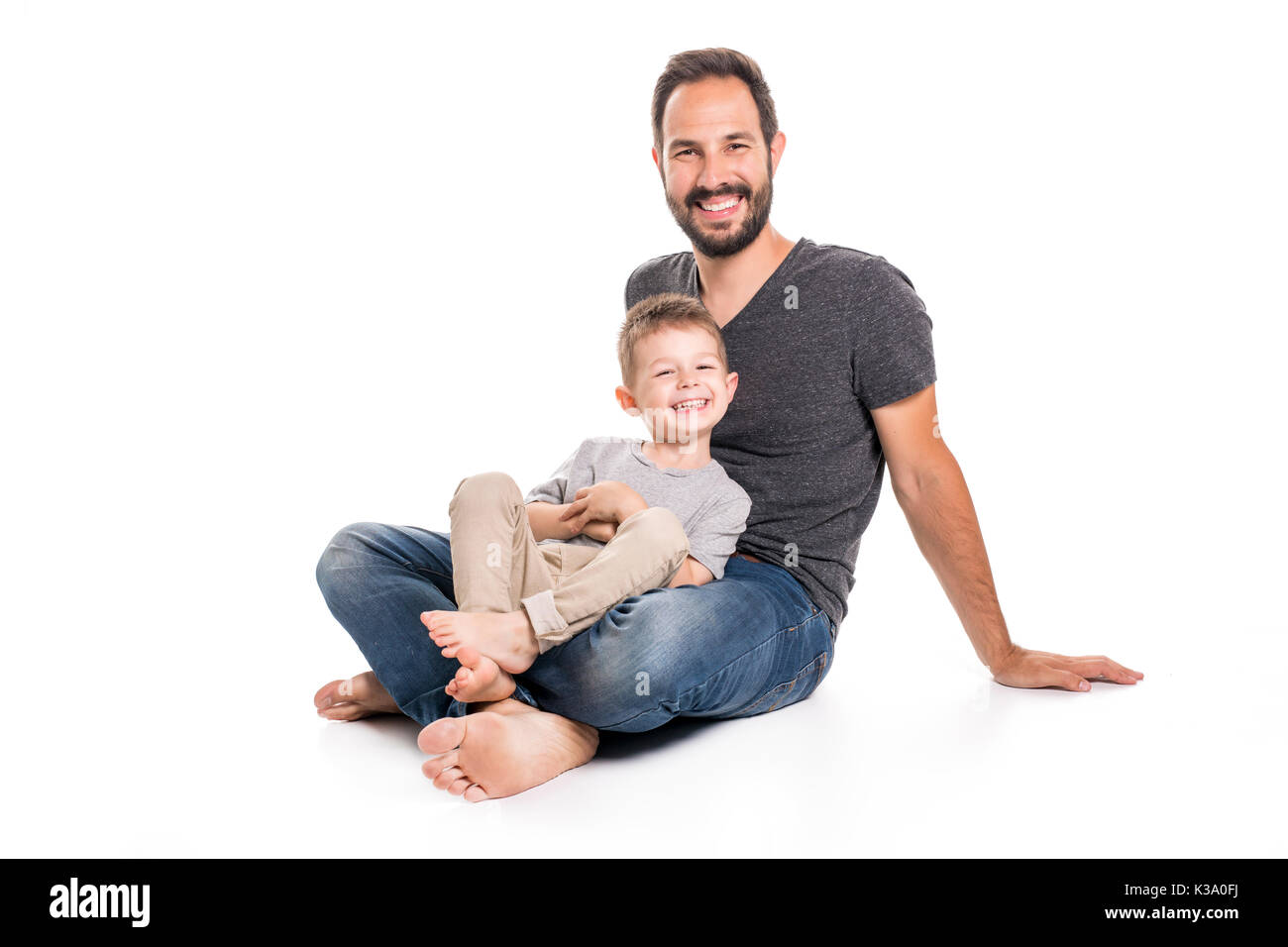 Father and son having fun over white background Stock Photo - Alamy