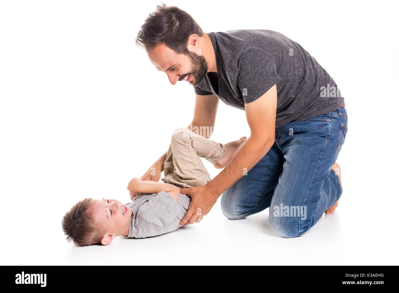 Father and son having fun over white background Stock Photo - Alamy