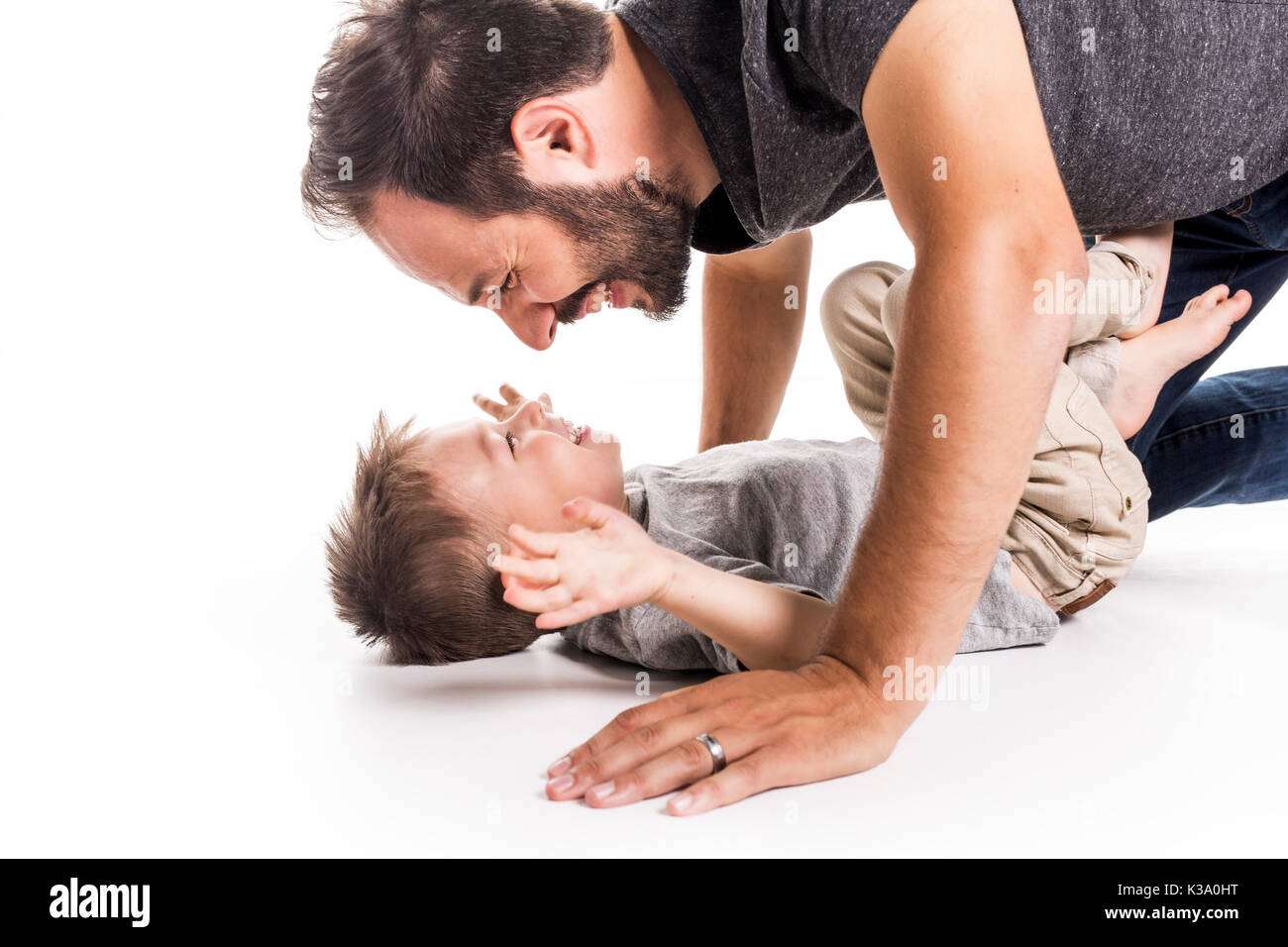 Father and son having fun over white background Stock Photo - Alamy