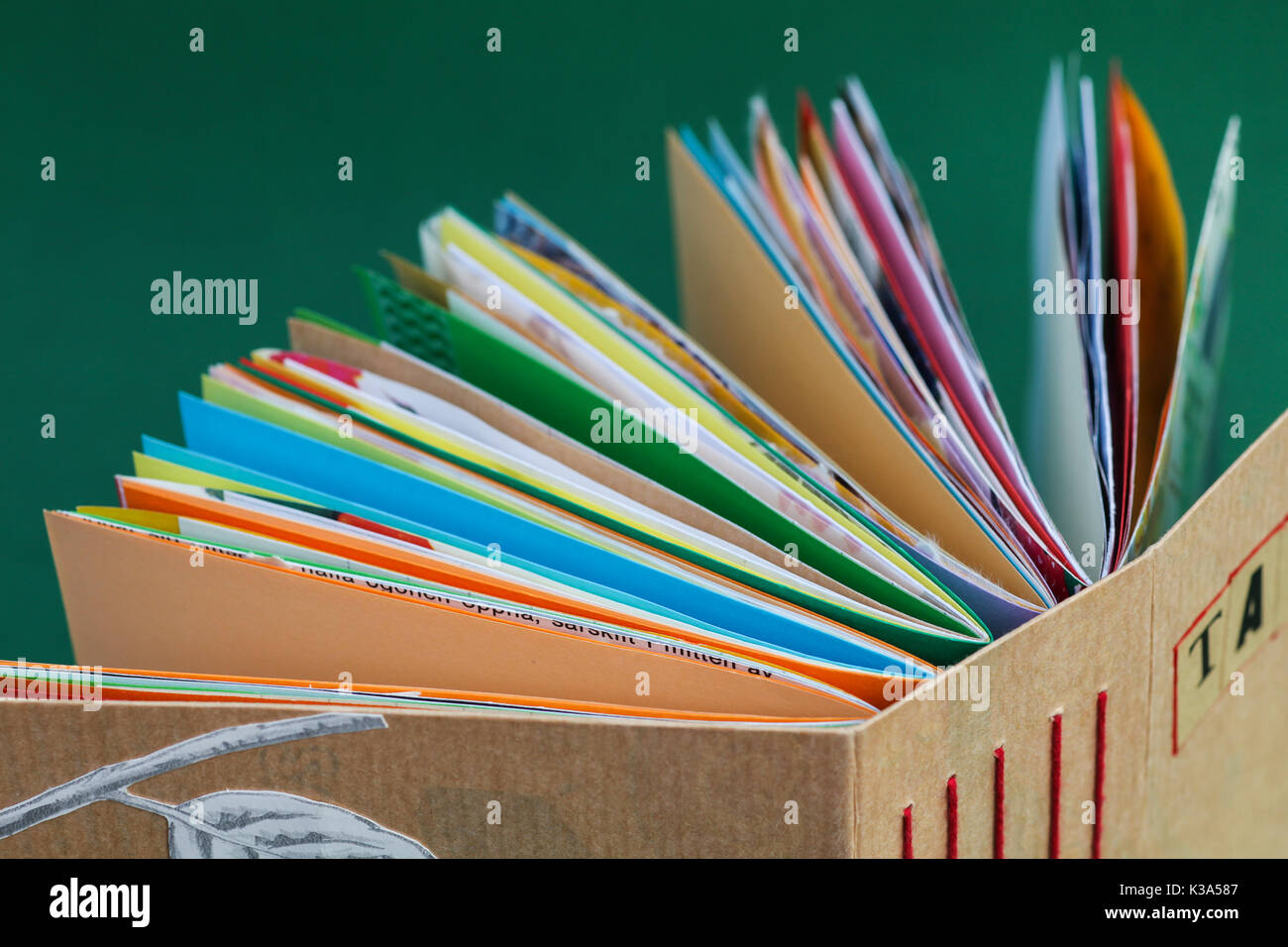 A colourful, homemade junk journal made from a recycled box and random ...