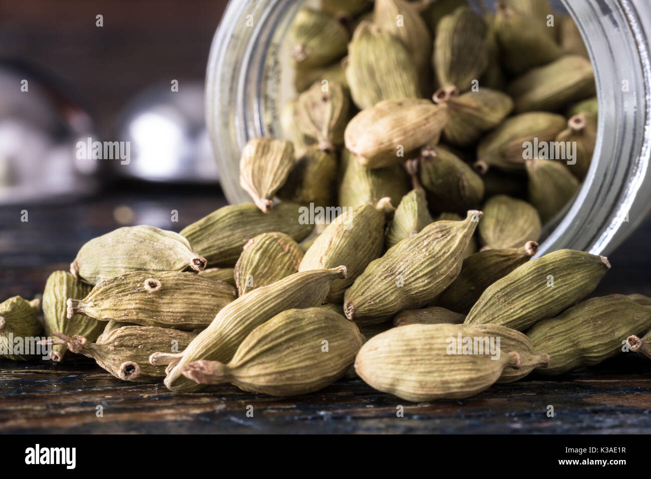 Green Cardamom Pods Spilling from Spice Jar Stock Photo - Alamy
