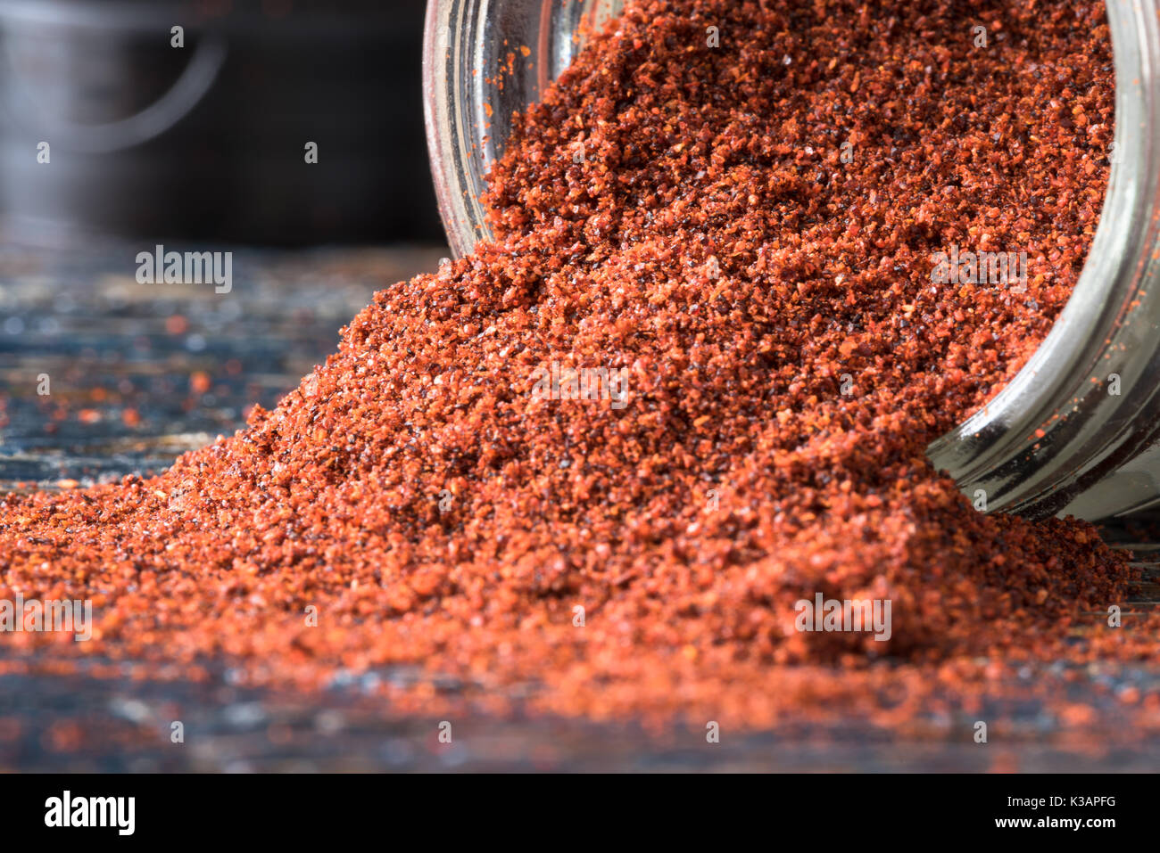 Ground Chipotle Powder Spilling from Spice Jar Stock Photo - Alamy