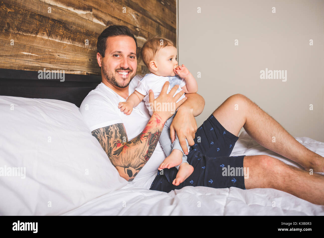 Portrait of a father with her nine months old baby Stock Photo - Alamy