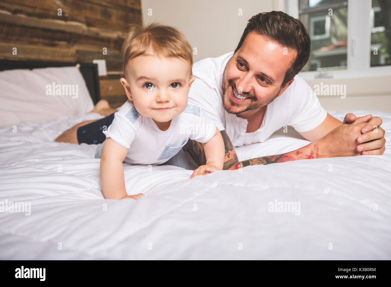 Portrait of a father with her nine months old baby Stock Photo - Alamy