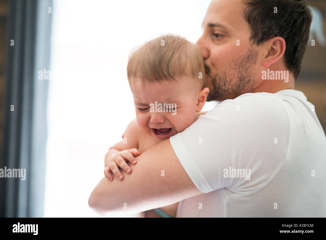 Baby sad face parent hi-res stock photography and images - Alamy