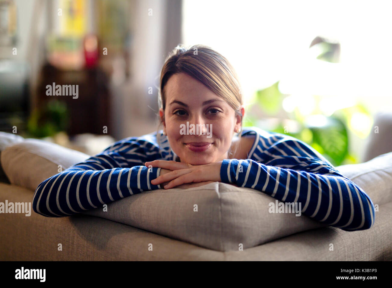 woman sitting on the couch take some good time Stock Photo - Alamy