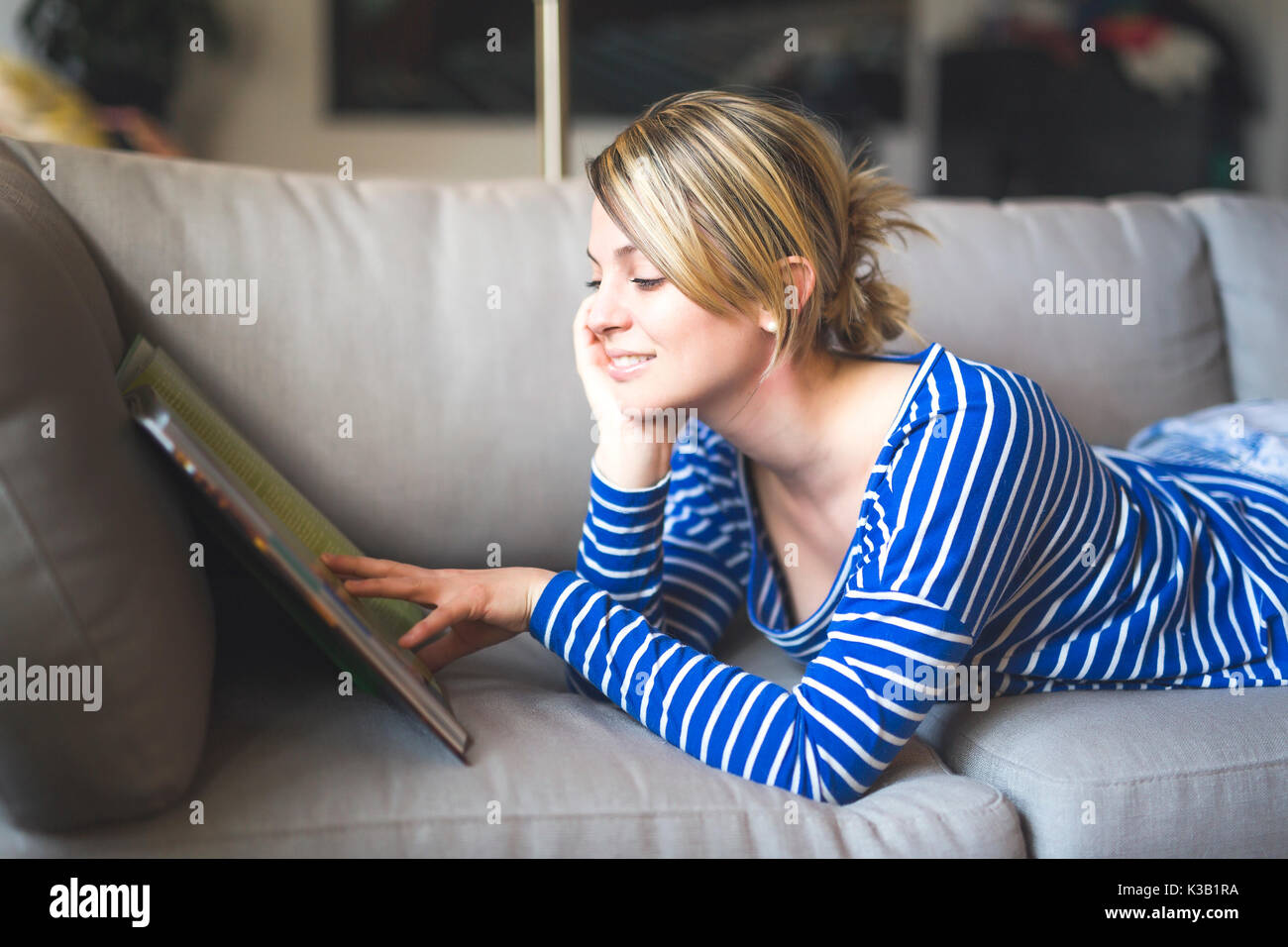 Good looking woman sitting on couch hi-res stock photography and images ...