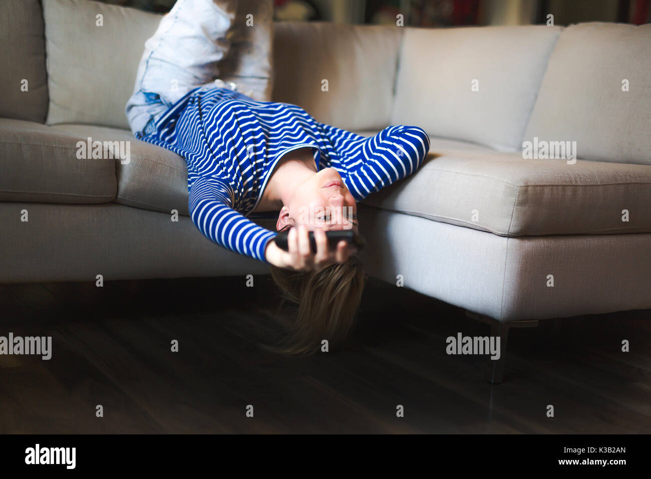 Woman upside down couch hi-res stock photography and images - Alamy