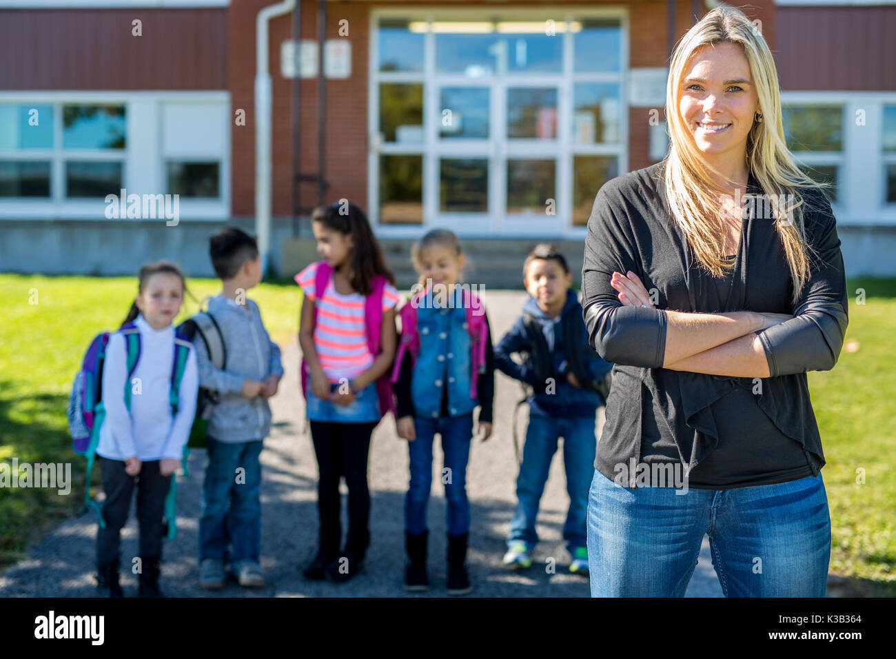students outside school teacher standing together Stock Photo - Alamy