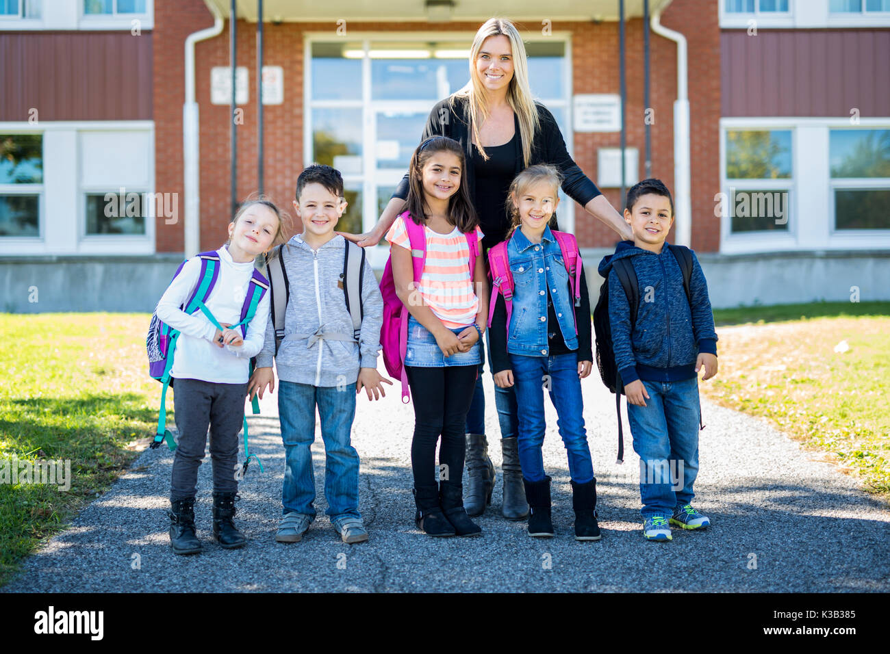 students outside school teacher standing together Stock Photo - Alamy