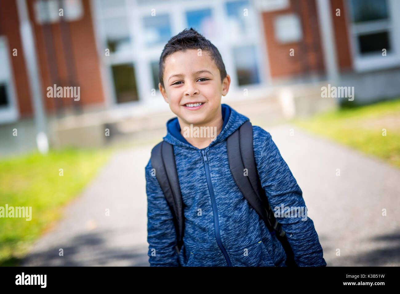 student outside school standing smiling Stock Photo - Alamy
