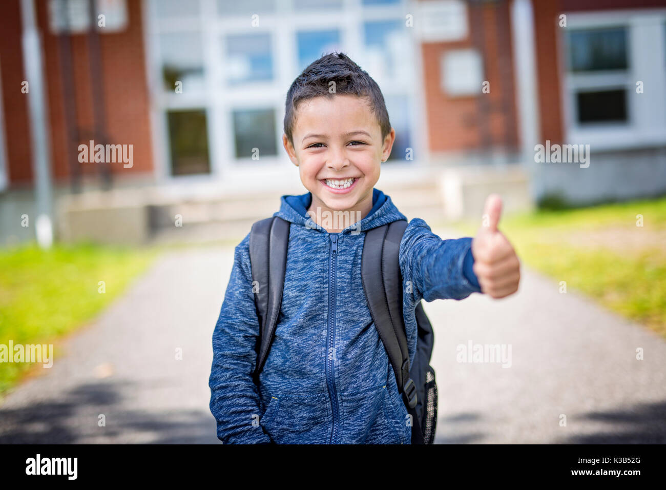student outside school standing smiling Stock Photo - Alamy