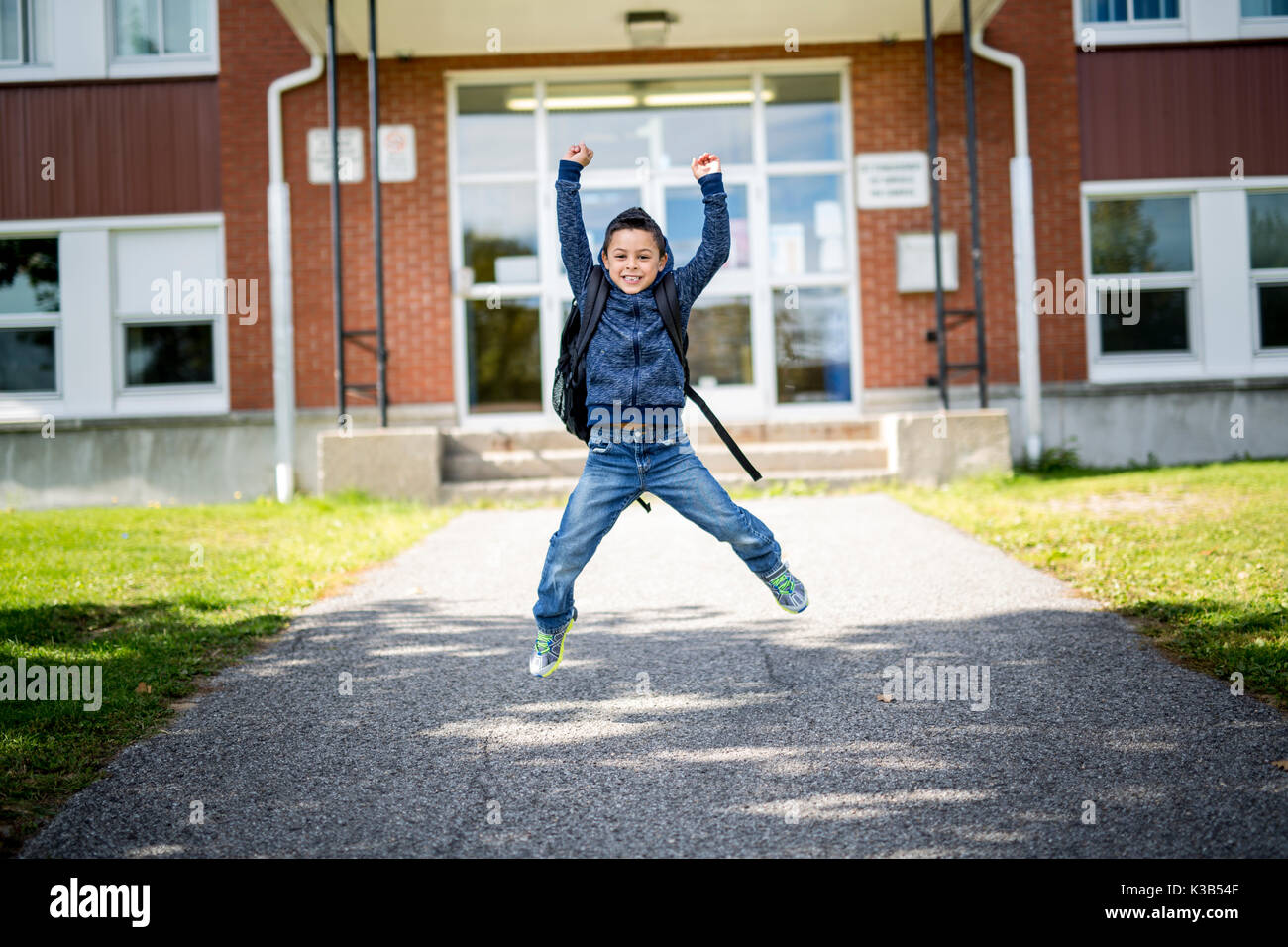 student outside school standing smiling Stock Photo - Alamy