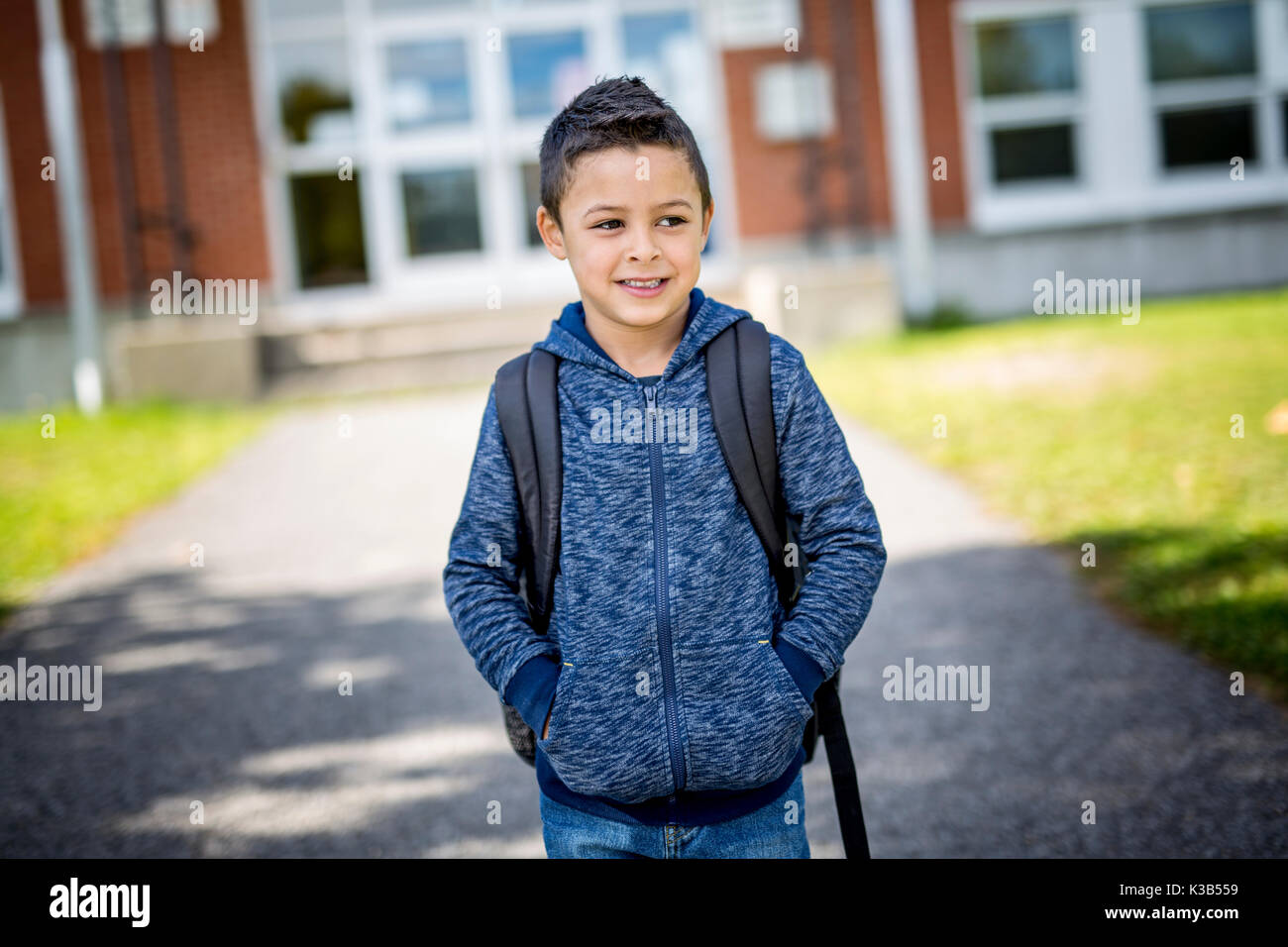 student outside school standing smiling Stock Photo - Alamy