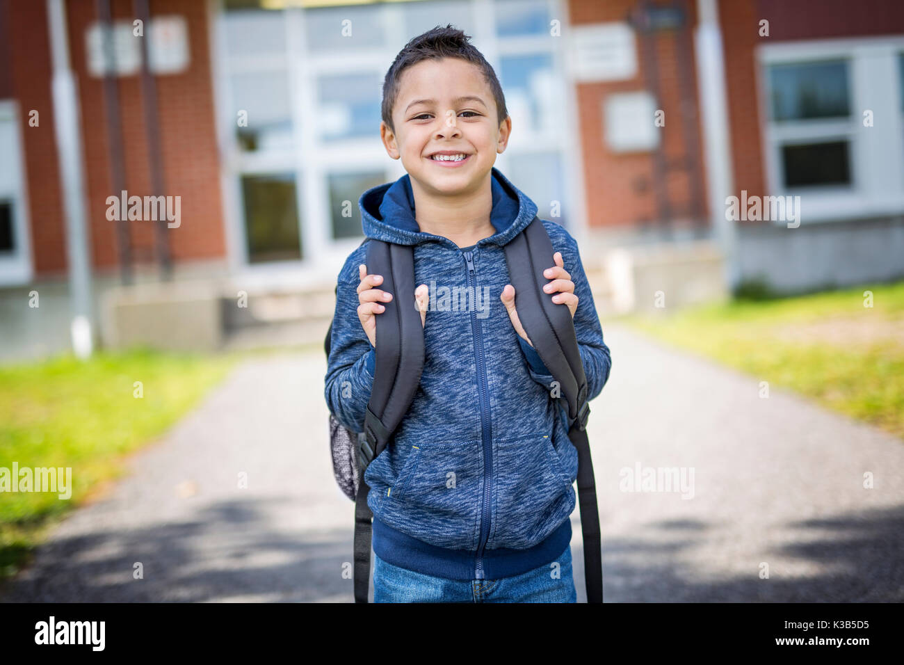 student outside school standing smiling Stock Photo - Alamy