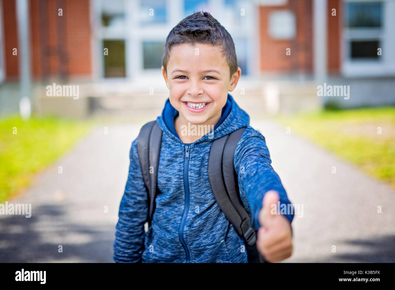 student outside school standing smiling Stock Photo - Alamy