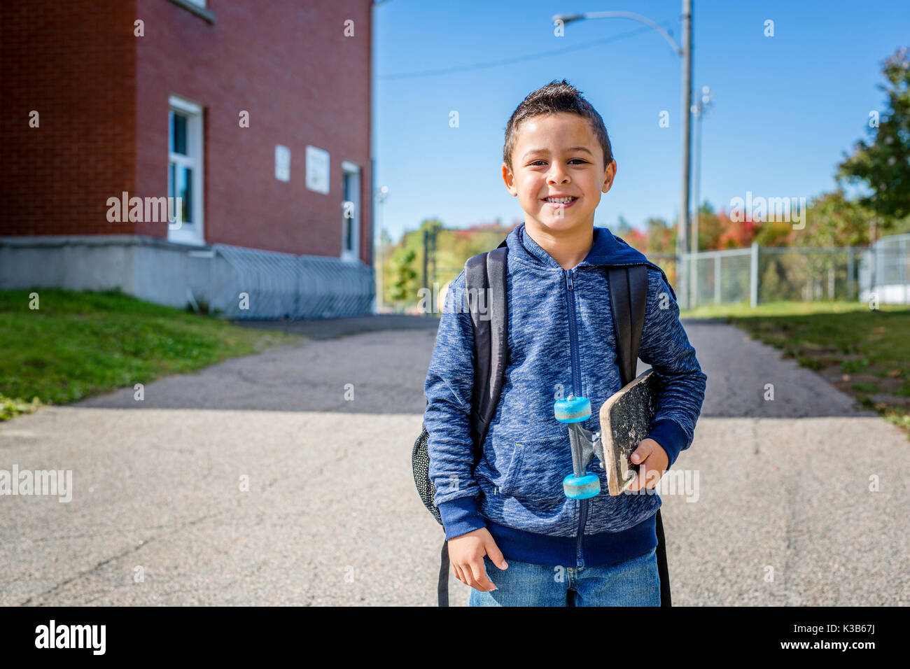 student outside school standing smiling Stock Photo - Alamy