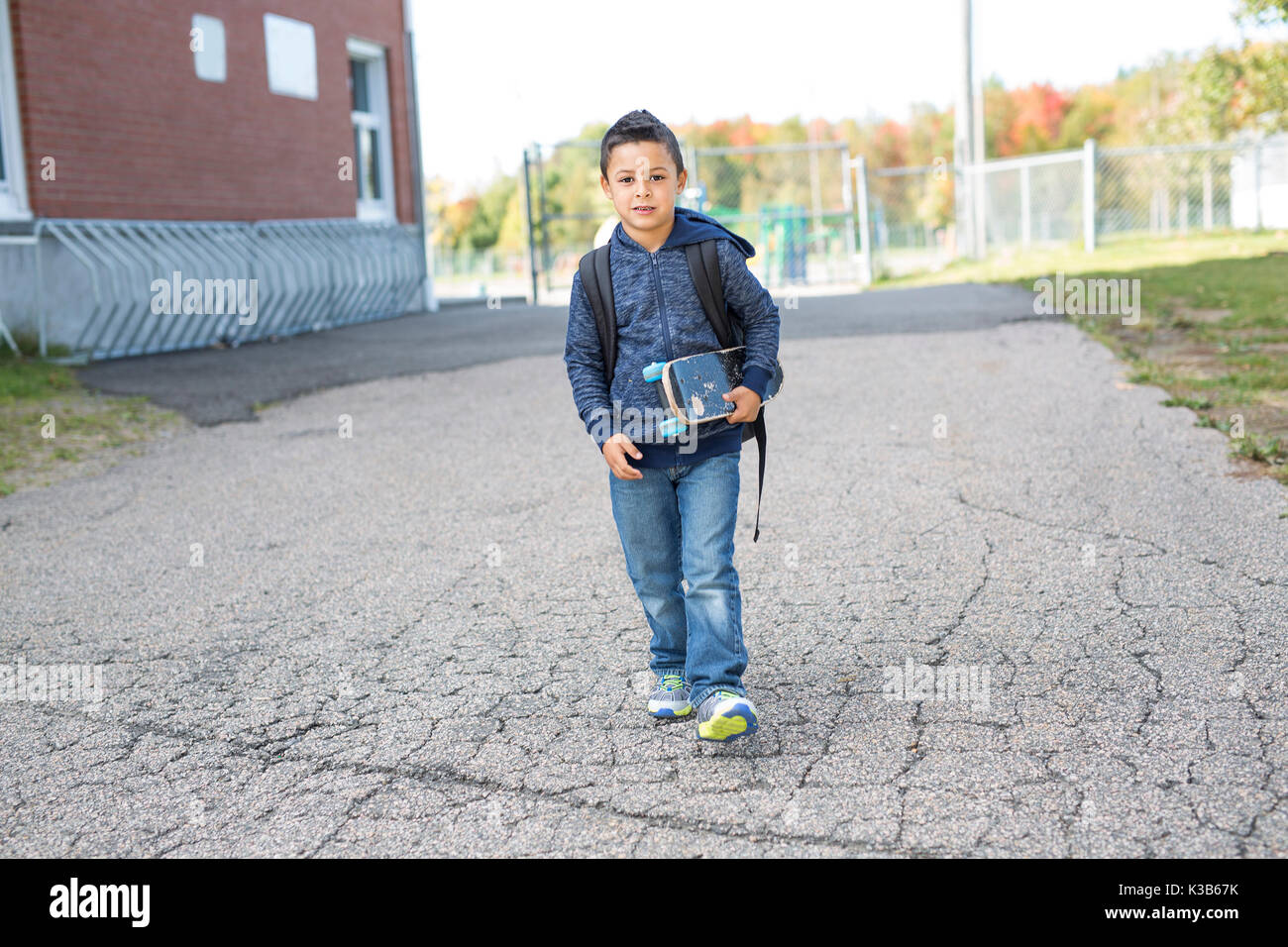 student outside school standing smiling Stock Photo - Alamy