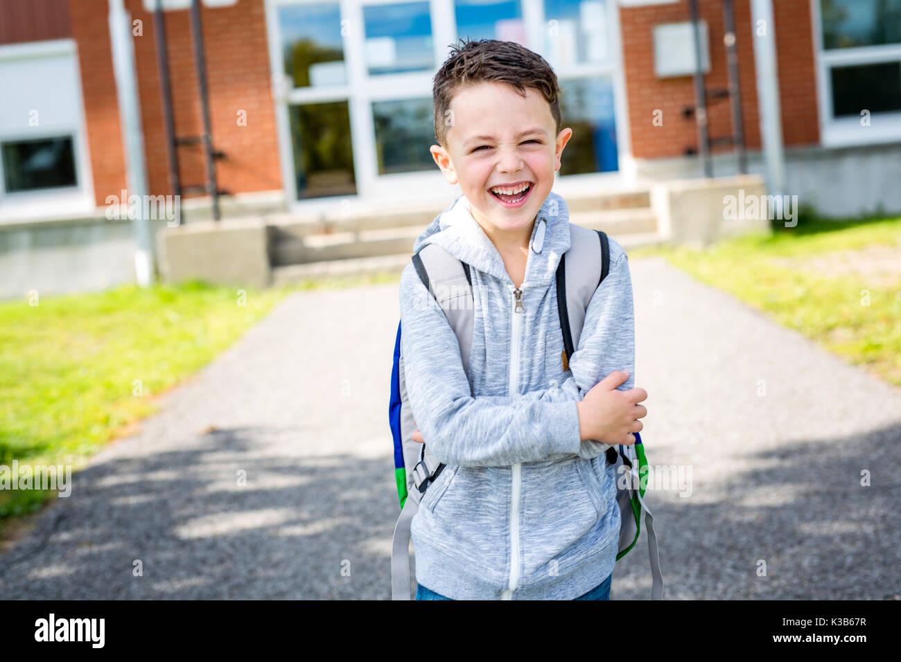 student outside school standing smiling Stock Photo - Alamy