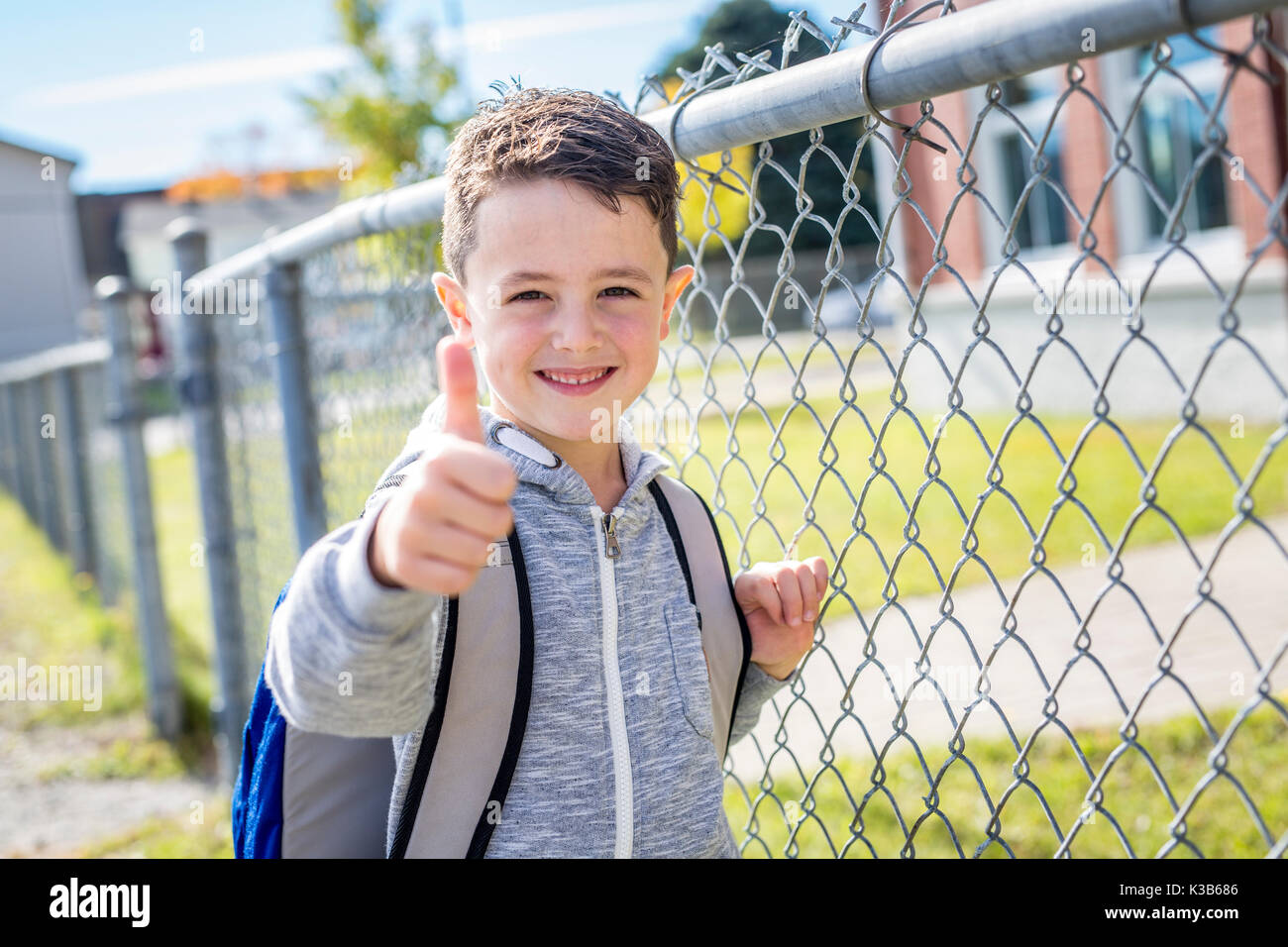 student outside school standing smiling Stock Photo - Alamy