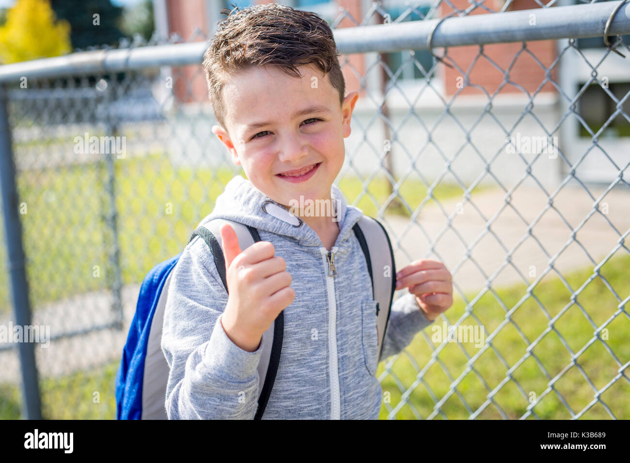 student outside school standing smiling Stock Photo - Alamy