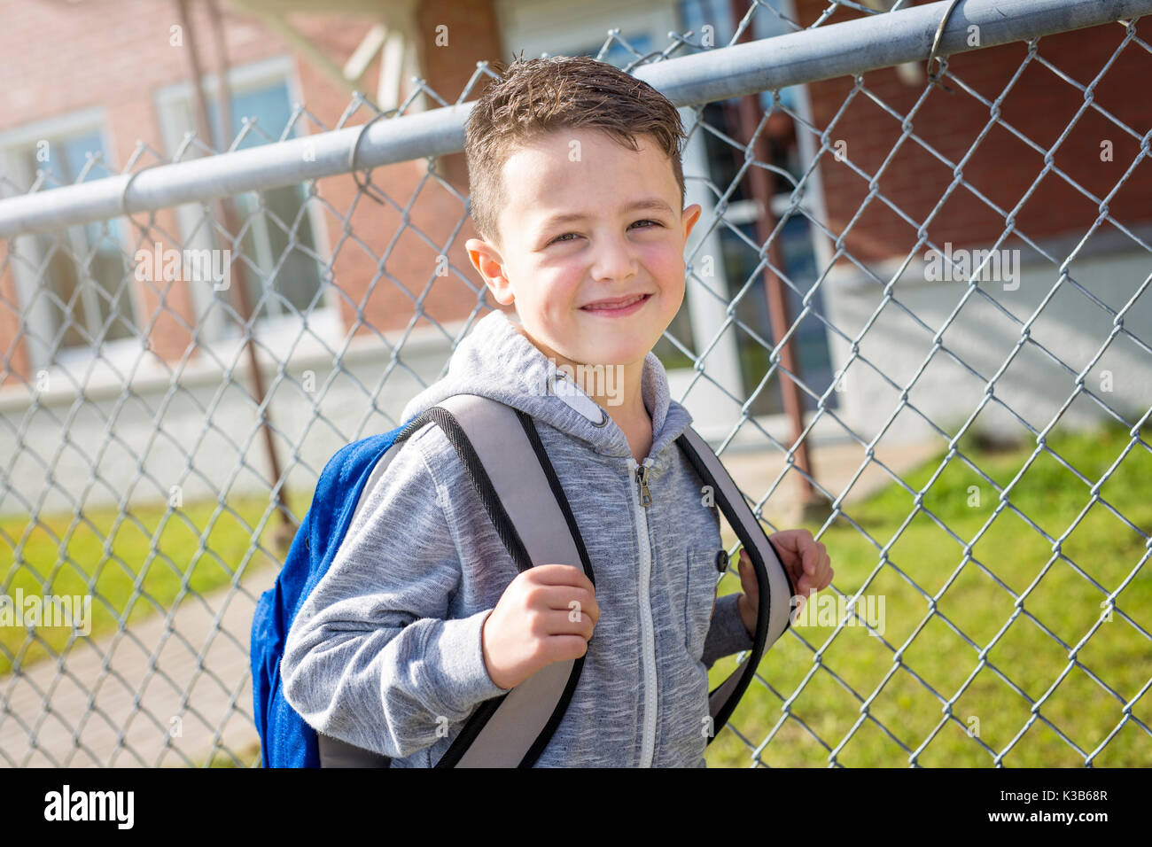 student outside school standing smiling Stock Photo - Alamy