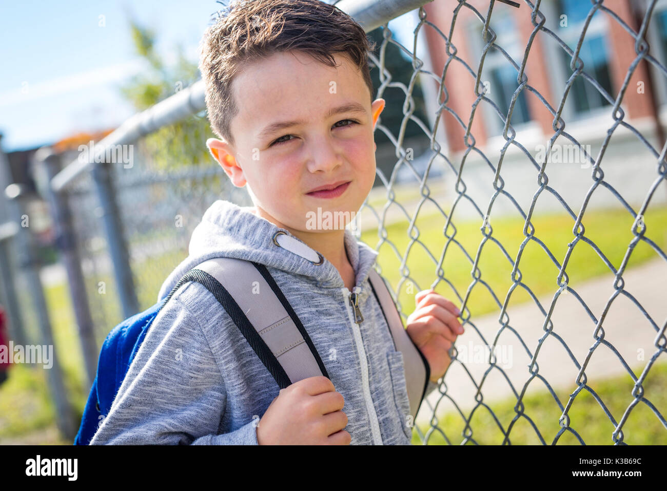student outside school standing smiling Stock Photo - Alamy