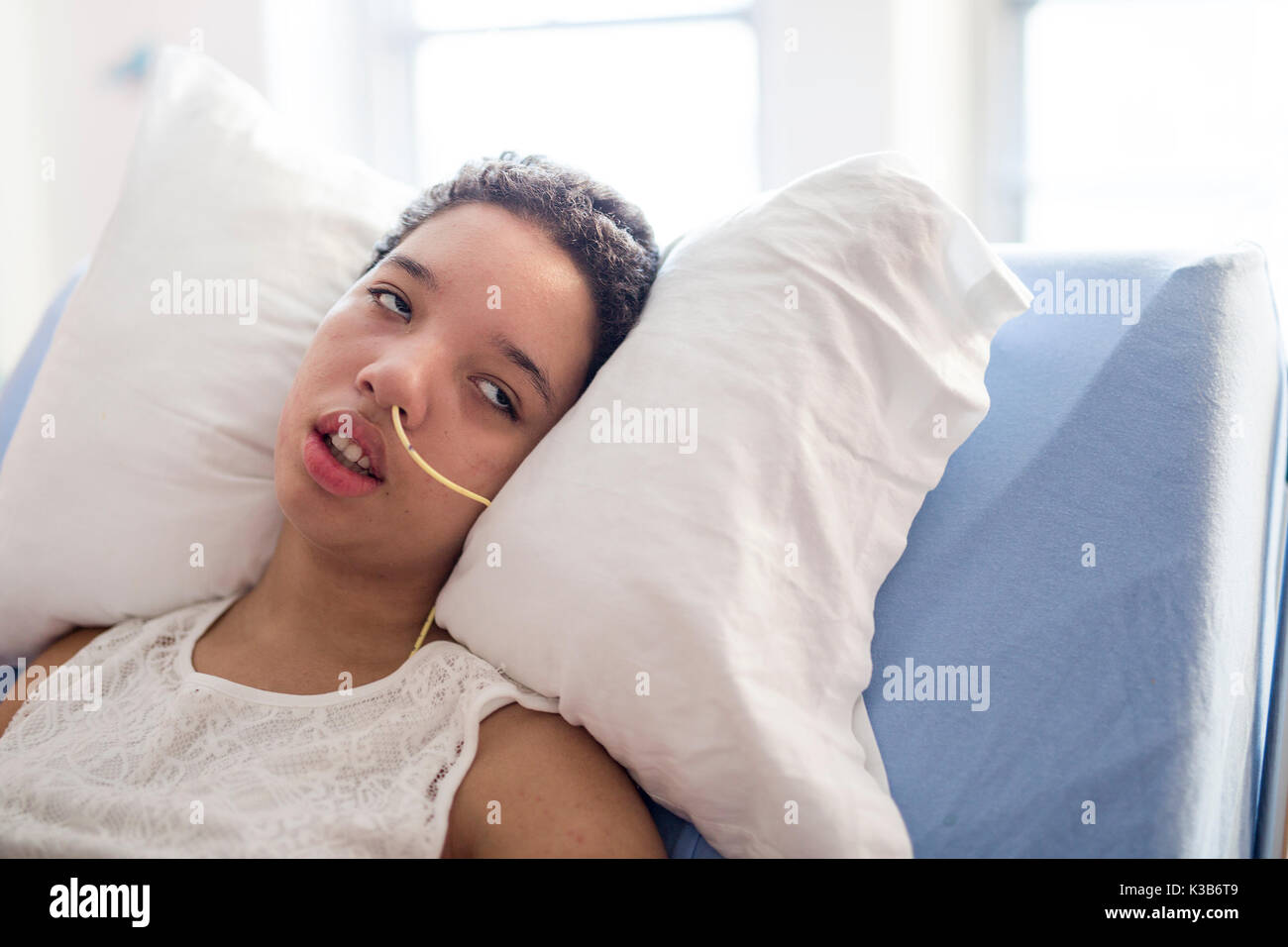 Sick patient lying on bed in hospital for medical background Stock ...
