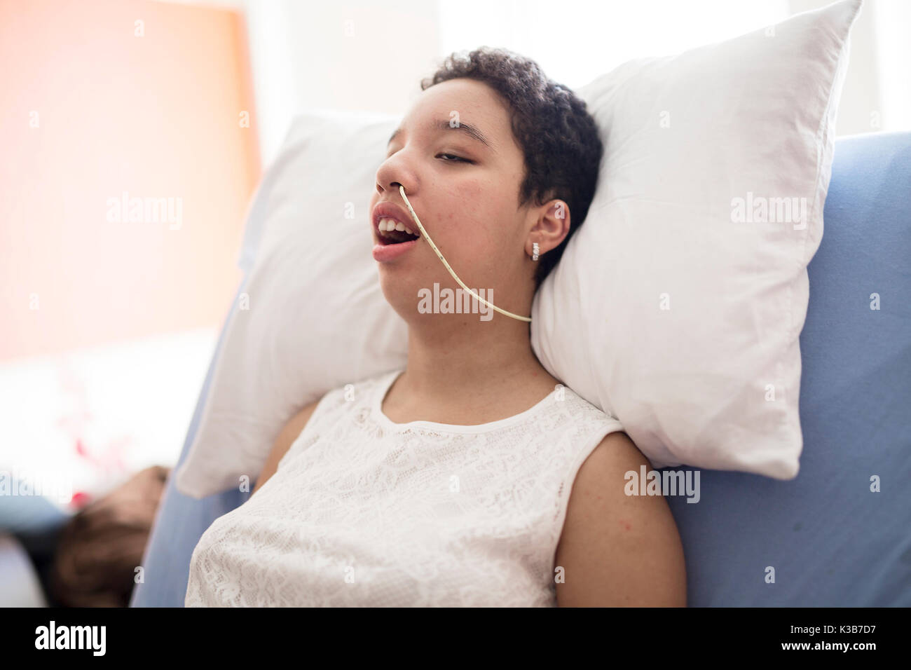 Sick patient lying on bed in hospital for medical background Stock ...