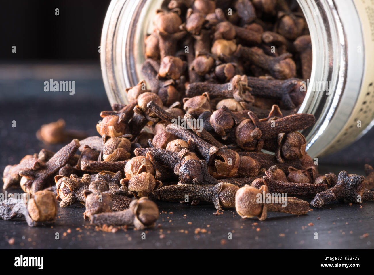 Whole Cloves Spilled from a Spice Jar Stock Photo - Alamy