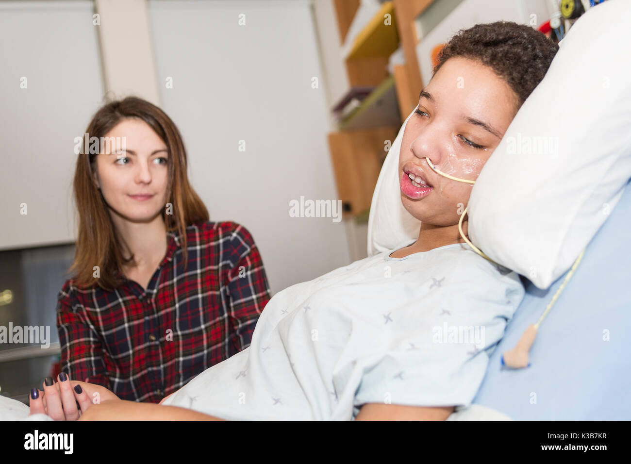 Sick patient lying on bed in hospital for medical background Stock ...