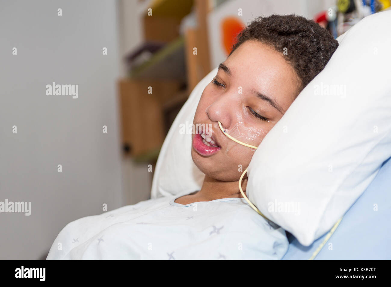 Sick patient lying on bed in hospital for medical background Stock ...