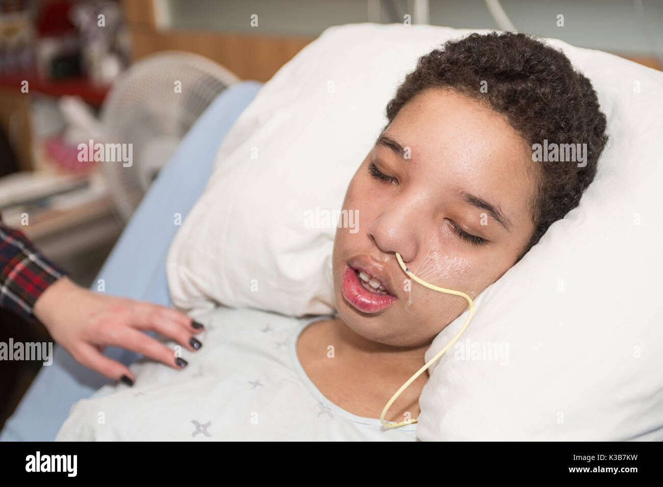 Sick patient lying on bed in hospital for medical background Stock ...