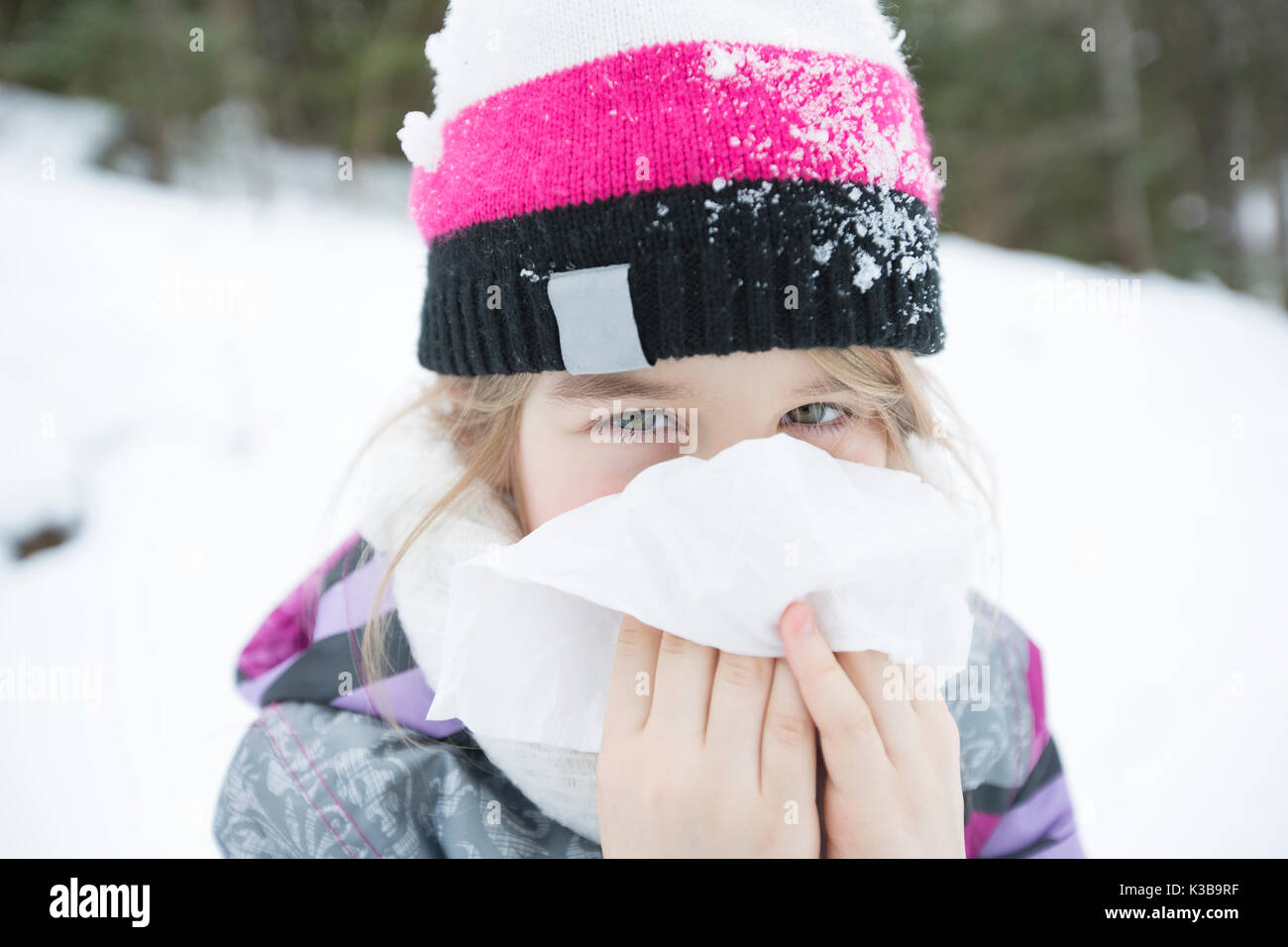 child with tissue outside in forest winter season Stock Photo - Alamy