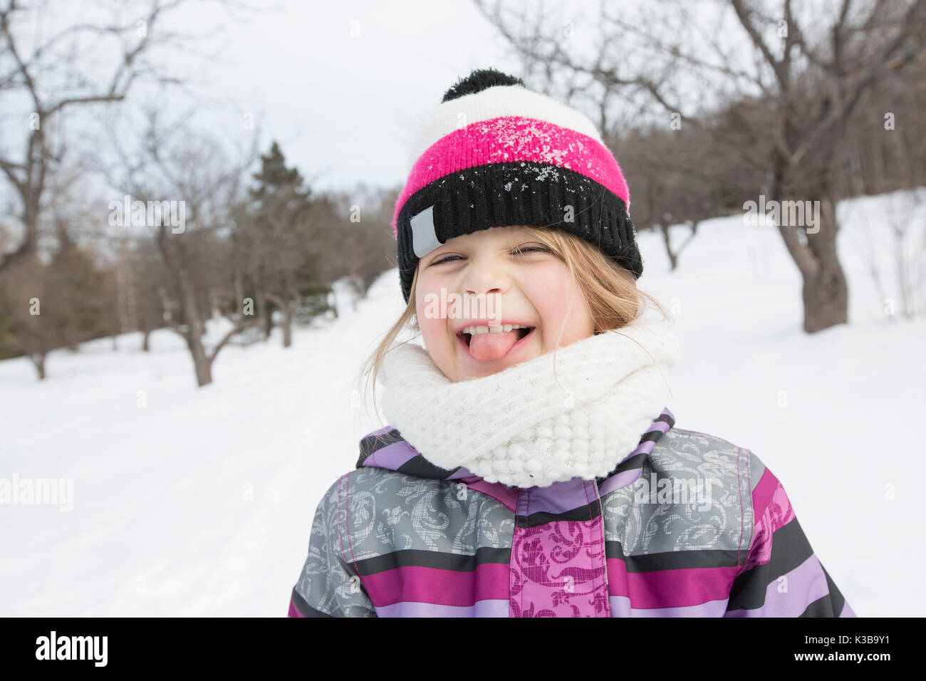 Little girl in winter pink hat in snow forest Stock Photo - Alamy