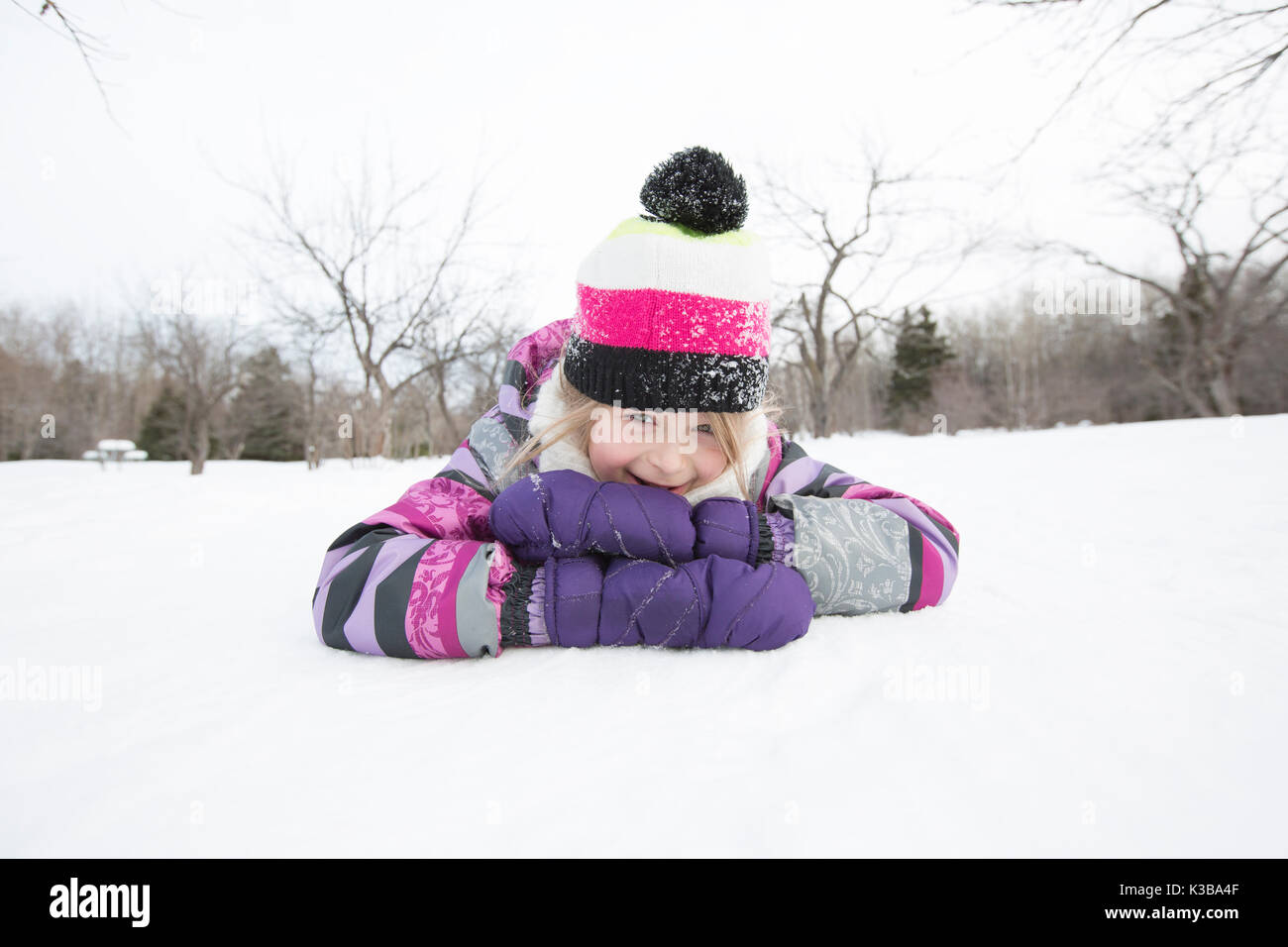 Little girl in winter pink hat in snow forest Stock Photo - Alamy
