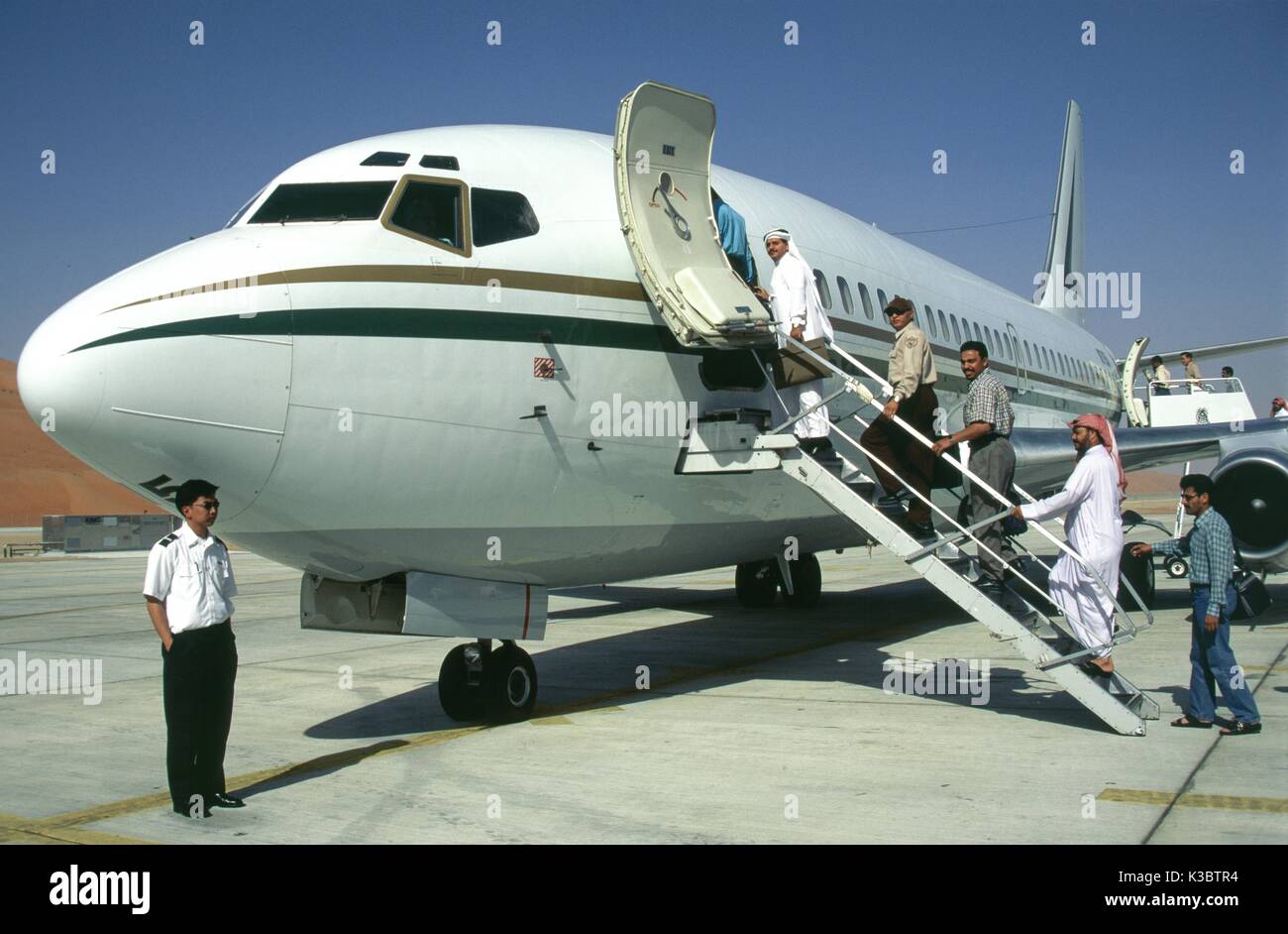 Saudi Aramco employees board the Saudi Aramco 737 company plane at ...