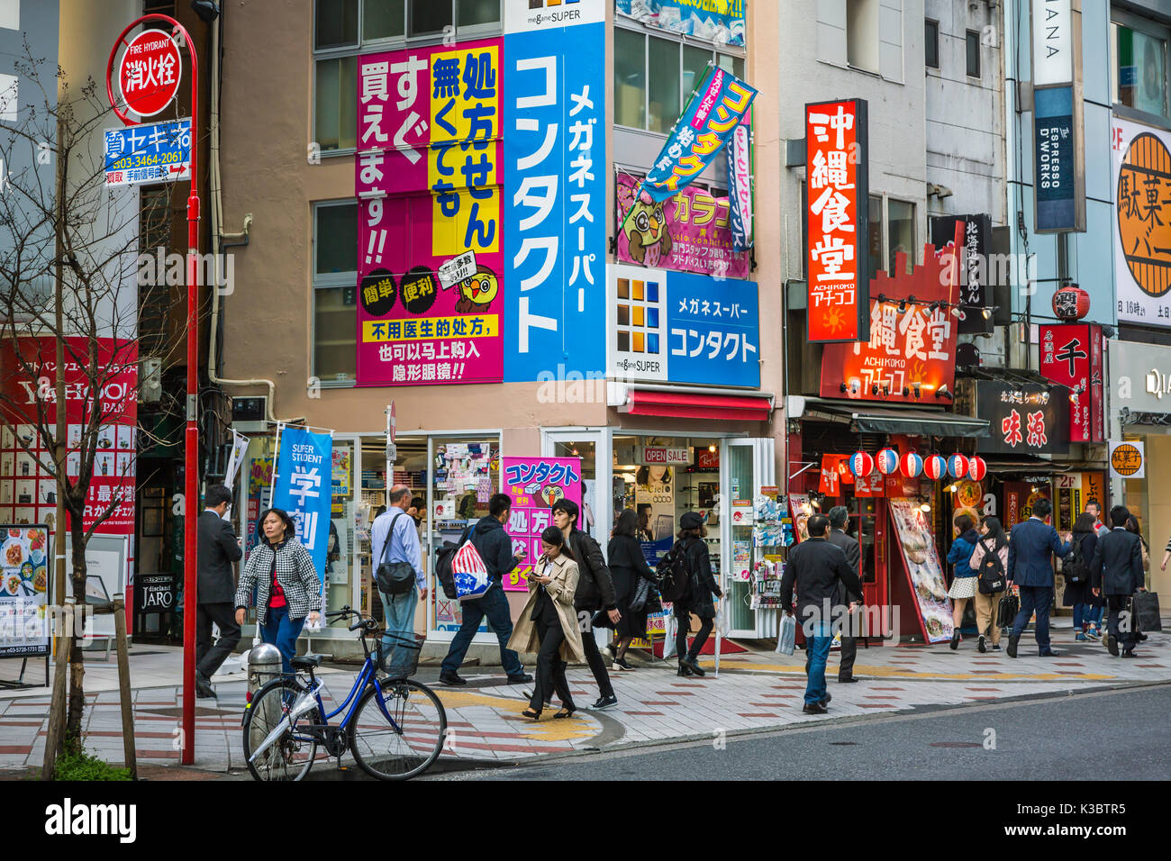 A shopping street with bright signs in the Shibuya district of Tokyo ...