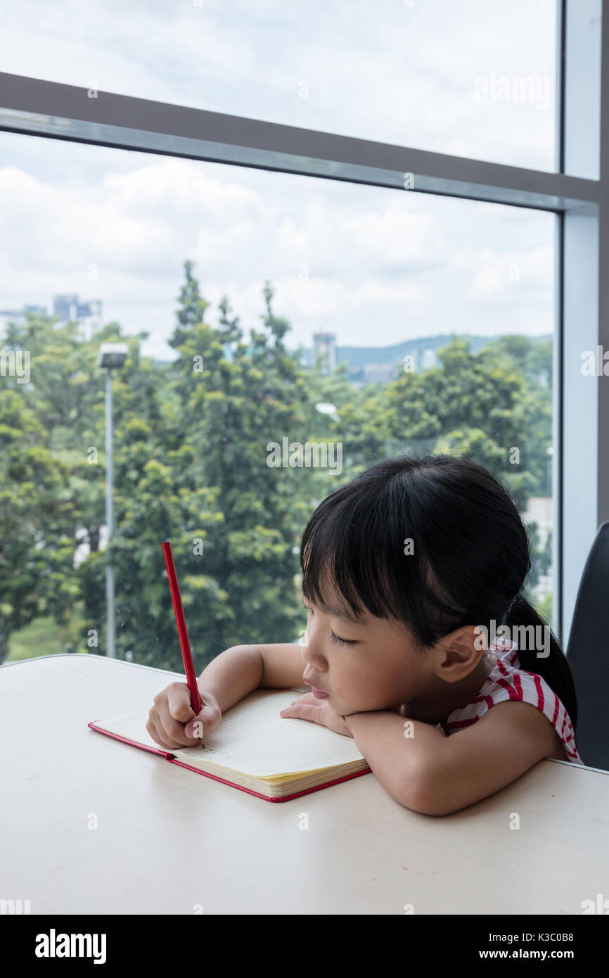 Asian little Chinese girl writing homework at home Stock Photo - Alamy