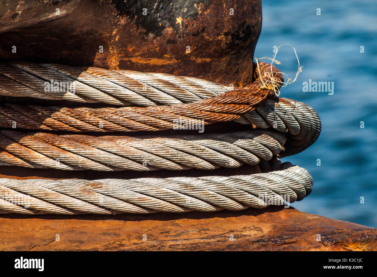 mooring bollard and cable at the harbour dock close up Stock Photo - Alamy