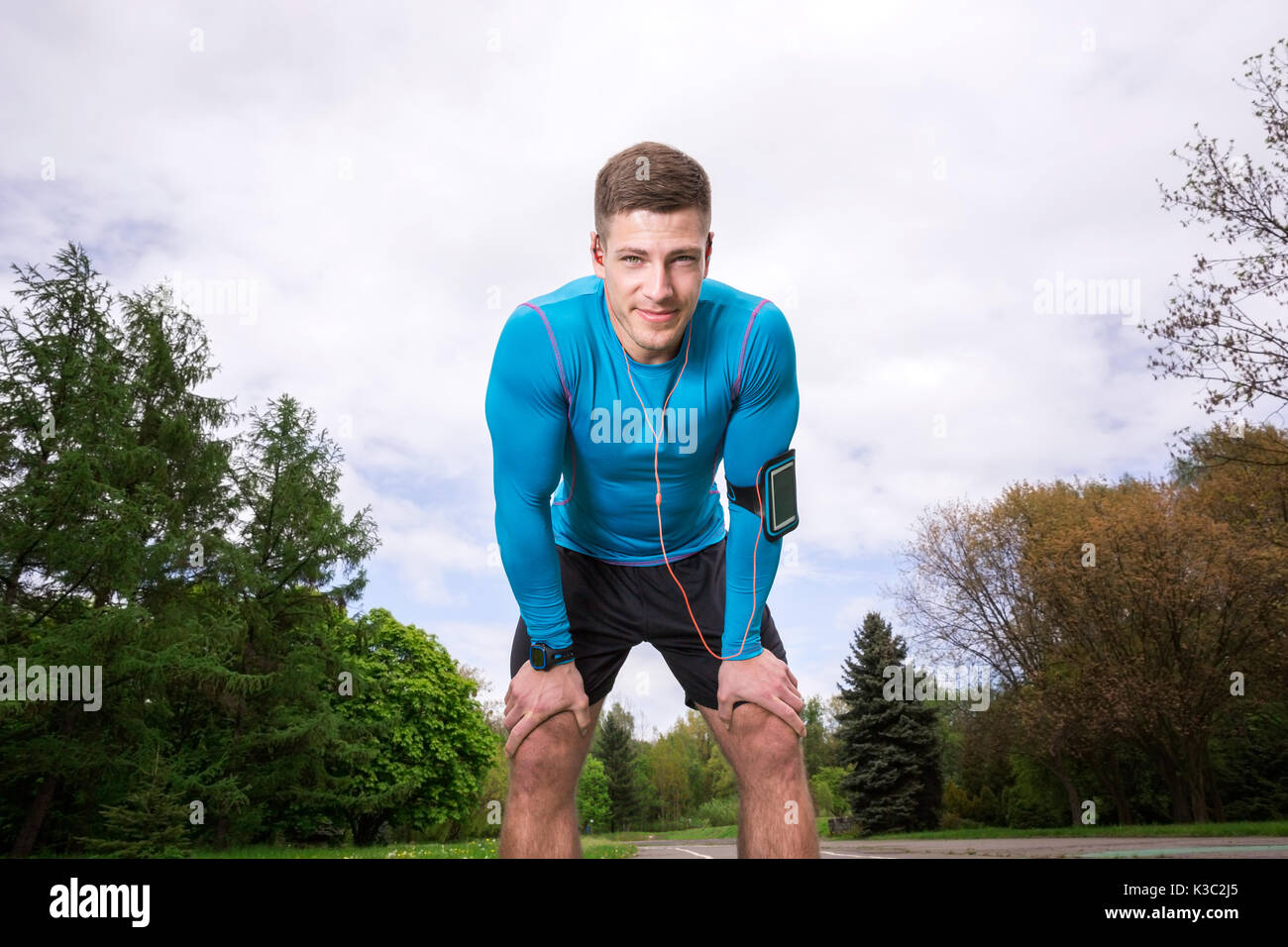 A photo of a young, muscular man in sports wear preparing for jogging ...