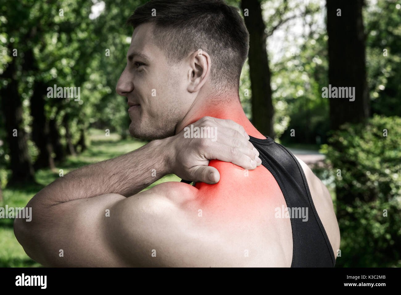 A photo of sporty man suffering from nape pain Stock Photo - Alamy