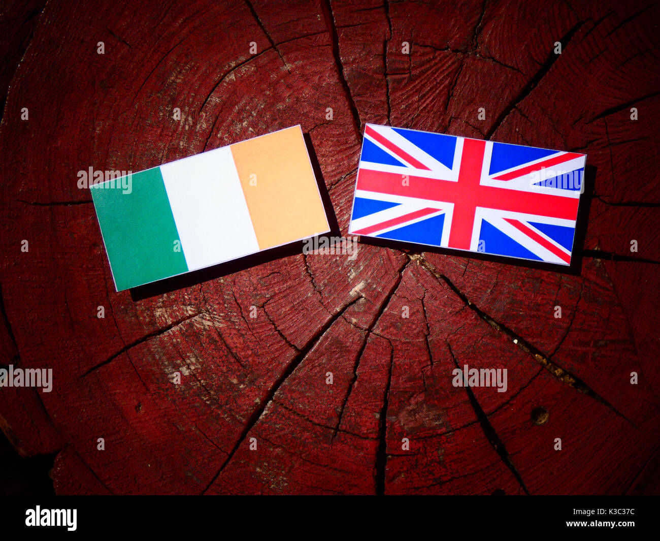 Irish flag with British flag on a tree stump isolated Stock Photo - Alamy