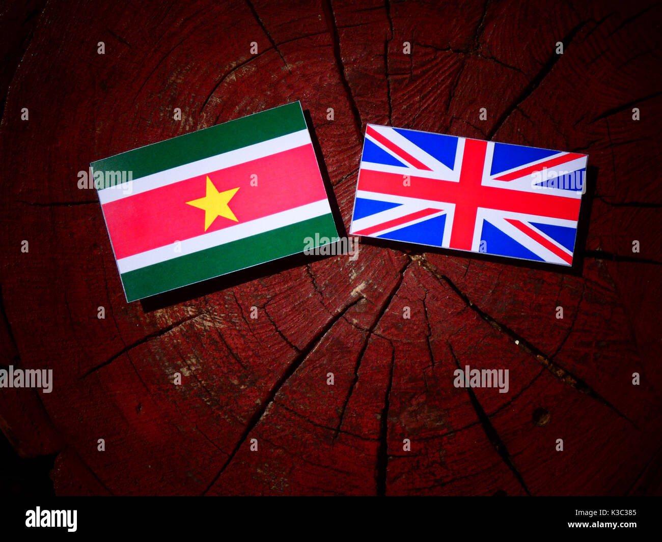 Suriname flag with British flag on a tree stump isolated Stock Photo ...