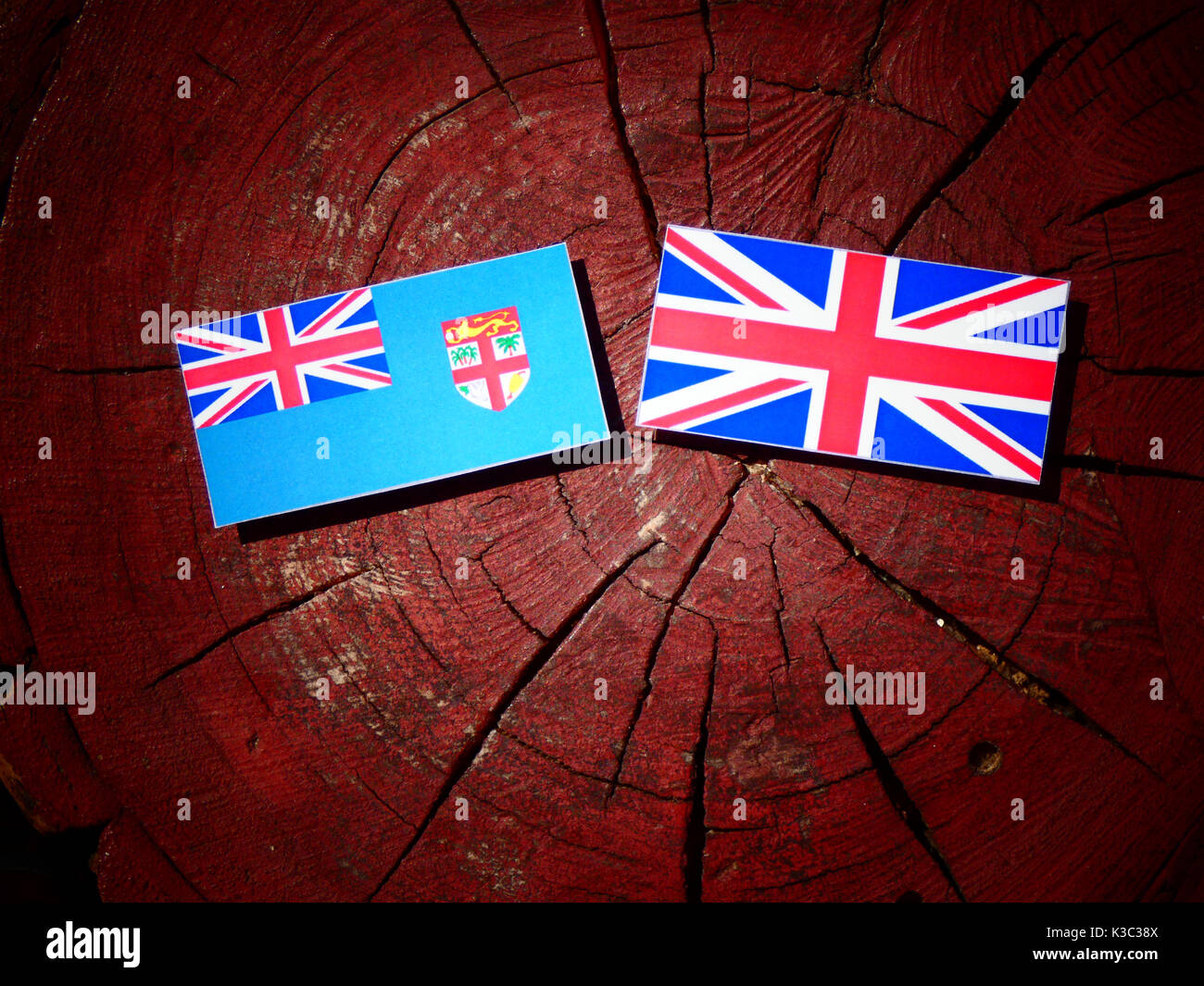 Fijian flag with British flag on a tree stump isolated Stock Photo - Alamy