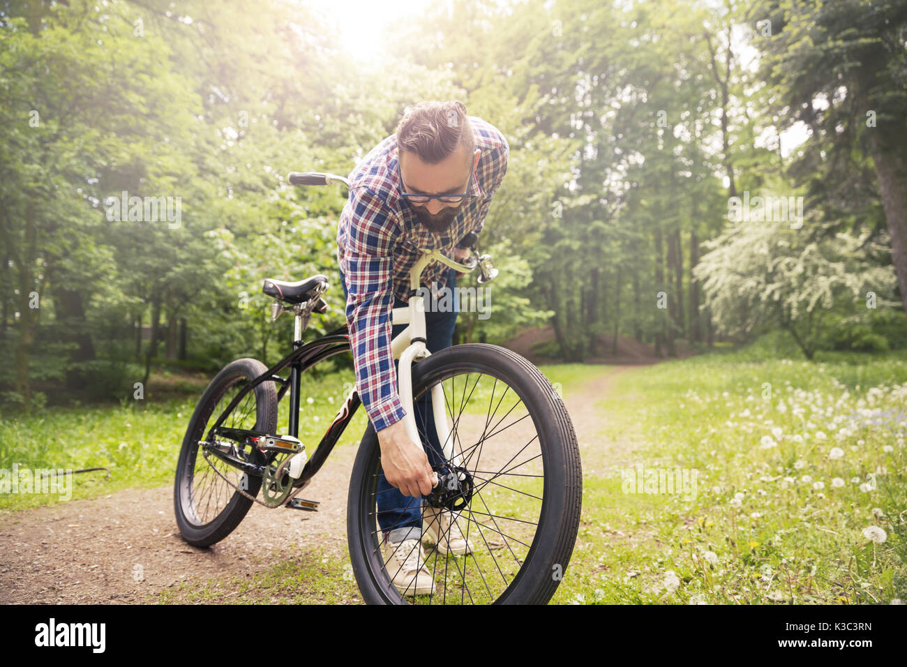 Man fixing bike hi-res stock photography and images - Alamy